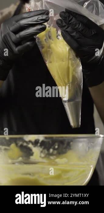 putting choux pastry for eclairs and profiteroles into a pastry bag ...