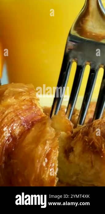 Cutting croissant with knife. Close up view. puff pastry bakery product ...