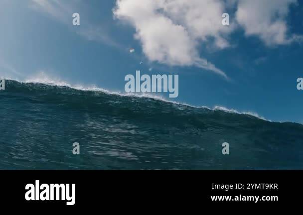 Ocean wave breaks. Underwater view of a surfing spot in the Maldives ...
