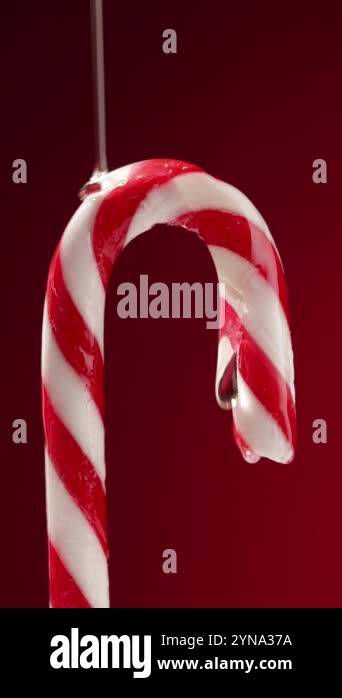 A captivating close-up of a candy cane with syrup dripping down its ...