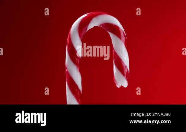A captivating close-up video of a classic candy cane with alternating ...