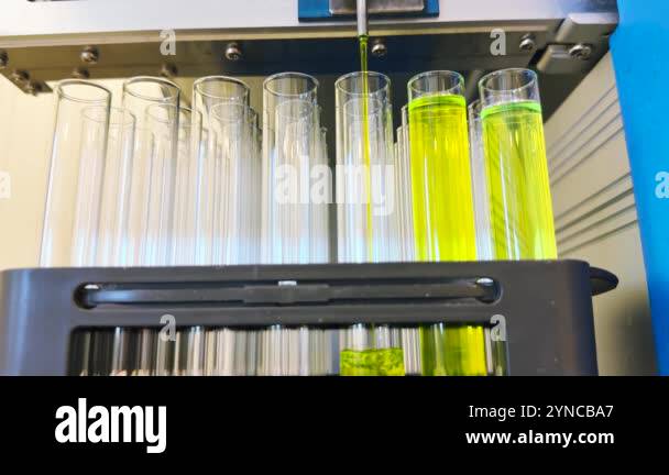 Green fluorescent compound is separated in automated machine. test tube ...