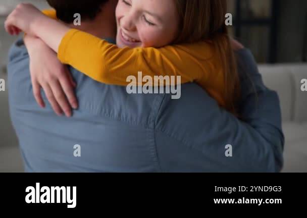 Caring positive Caucasian dad male holding little smiling daughter girl ...