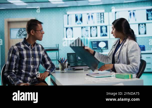 Indian medical staff and male patient engaging in a check up exam with ...
