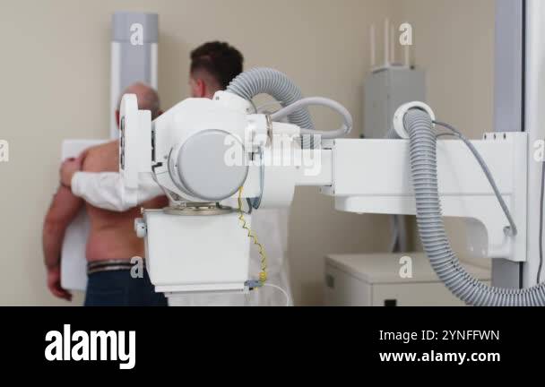 male doctor in medical uniform preparing patient to mri scan in the ...