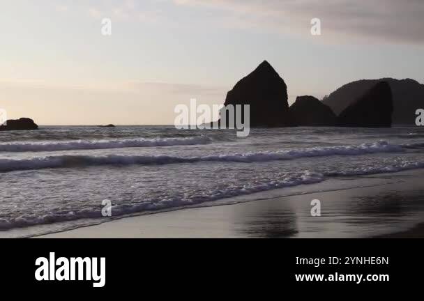 Ocean Waves With Large Rocks And Sand Beach Pale Blue Sky With Clouds ...