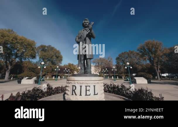 A 4K wide-angle shot of the Louis Riel sculpture, a historical monument ...