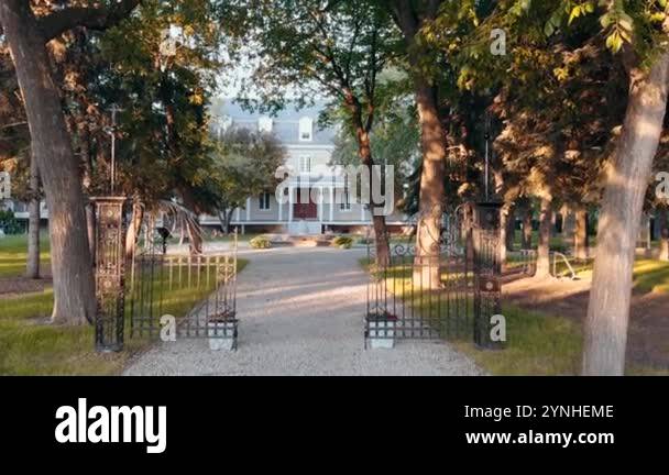 Cinematic 4K footage of a walk toward an old boarding house at sunset ...