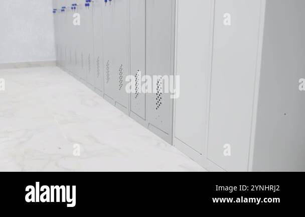Row of iron lockers for personal belongings in spacious locker room of ...