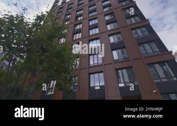 Modern office building reflects clouded sky on windows. Business center ...