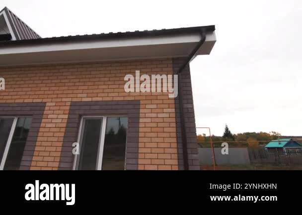 New brick building equipped with modern double-glazed windows and slate ...