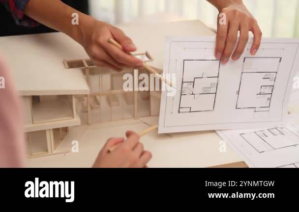 Interior designer drafting blueprint with customer supervise and ...