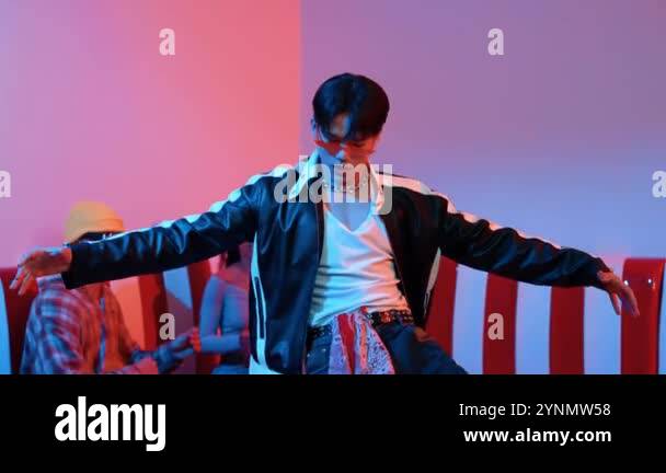 Asian man standing and dancing with pop music while multicultural ...