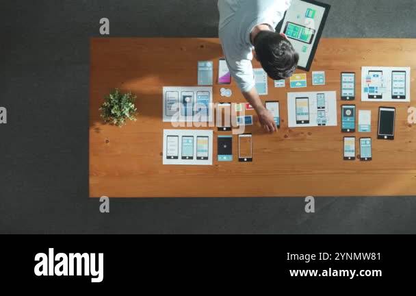 Top view of skilled developer walking and placing Ux Ui software. Smart ...