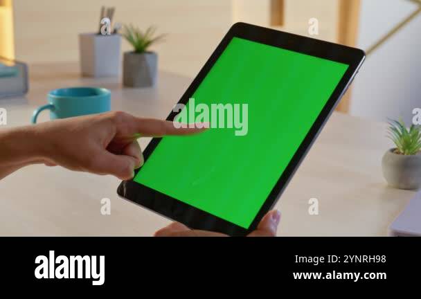 Hands tapping mockup tablet at remote workplace closeup. Unknown woman ...