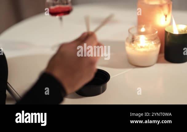 Beautiful woman eating sushi rolls at home. Cozy romantic atmosphere ...