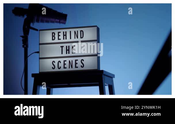 Behind the scene light box in front of vdo camera frame. Black text on ...