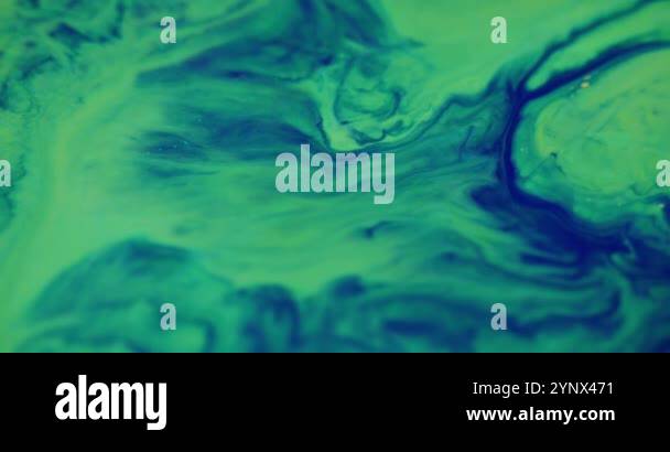 Acrylic fluid. Paint leaking. Green blue enamel mixing with sparkles ...