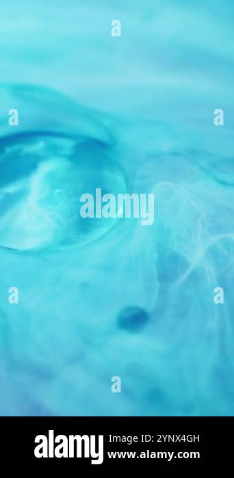Vertical video. Ink water mix. Paint fluid drop. Blur translucent blue ...
