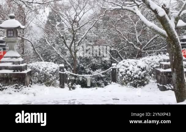 First snow falling on the rock lantern in shrine temples in Kurama ...