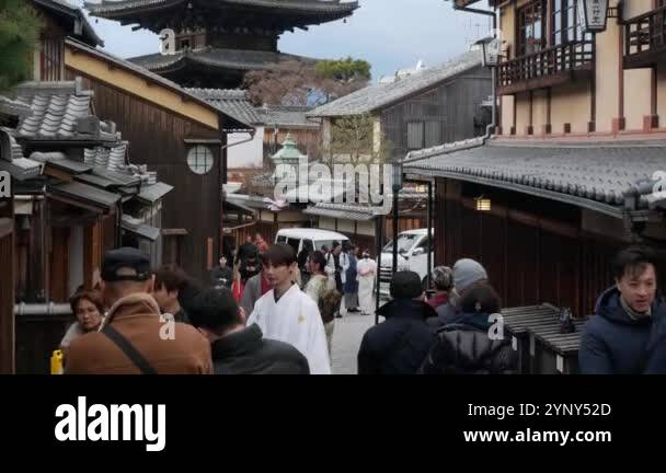 January26,2024.Kyoto,Japan.tilt up landscape street alley view with crowded people tourist leads ...