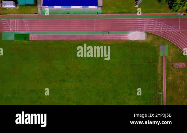 Aerial view of a running track and sports field with vibrant green ...