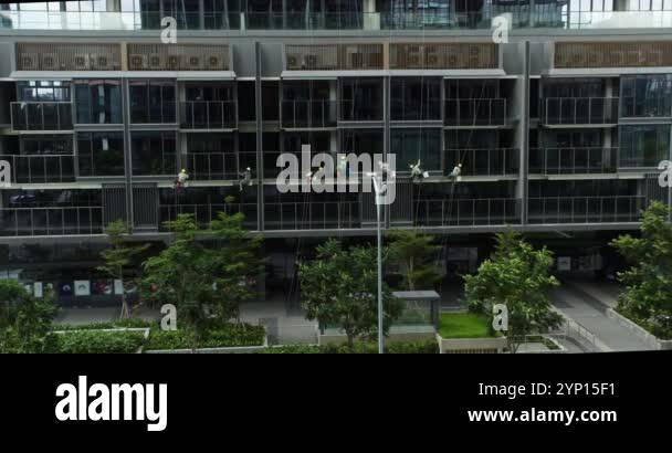 Window washers using industrial climbing techniques clean the facade of ...