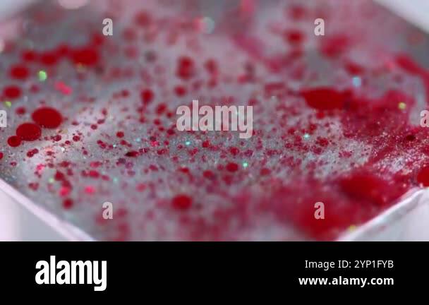 Ink drip. Glitter fluid texture. Blur red color shiny sequin particles ...