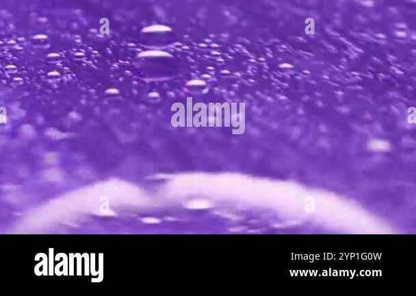 Fizzy liquid. Serum gel. Defocused neon purple blue color glitter ...