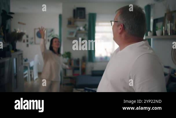 Man turning to face woman during argument in living room, couple ...