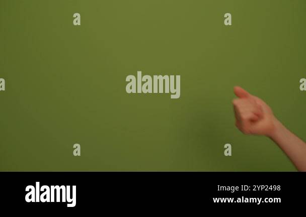 A hand is extended outward on a vibrant green backdrop, symbolizing a ...