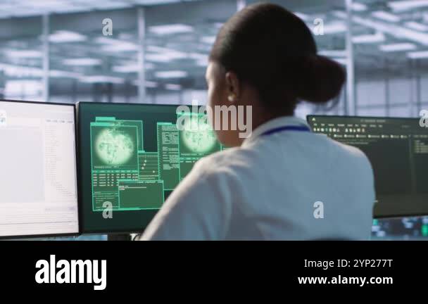 Woman seeing critical error on PC screen in data center, requesting help from cybersecurity team ...