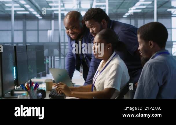 Data center coworkers laughing, having fun while maintaining company ...