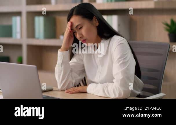 Unhealthy sick depressed sad Korean Asian businesswoman office worker ...