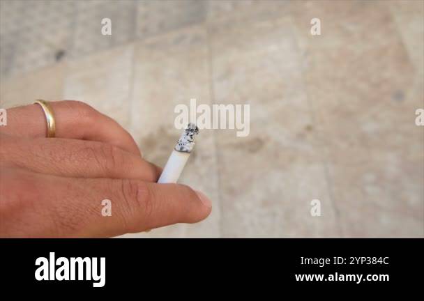 Slow motion view of Man hand while smoke a cigarette, tobacco drug ...