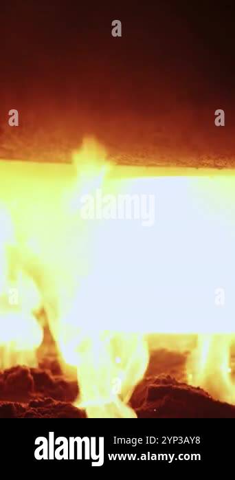In an incredibly intense industrial scene, flames erupt and molten ...