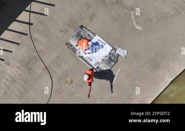 Soar over engineers collaborating on architectural plans for a new ...