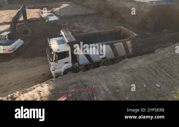 Watch from above as an excavator breaks ground on a new development ...