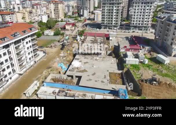 Watch the building progress as workers bend rebar and pour concrete ...