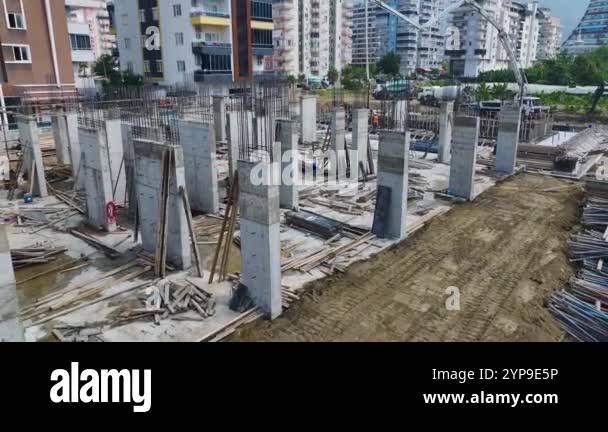 Watch construction workers carefully pouring concrete to build the base ...