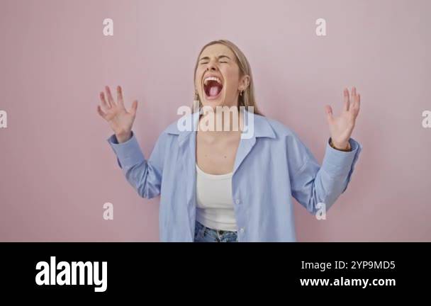 Frustrated young blonde woman yelling in mad rage! wearing shirt, arms ...