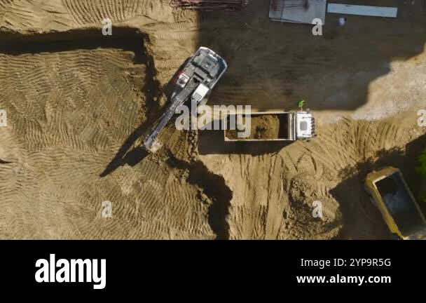 Watch the foundation-building process as an excavator loads soil into ...