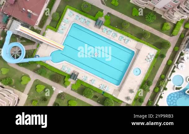 See the serene pool area in an exclusive complex, captured from above ...