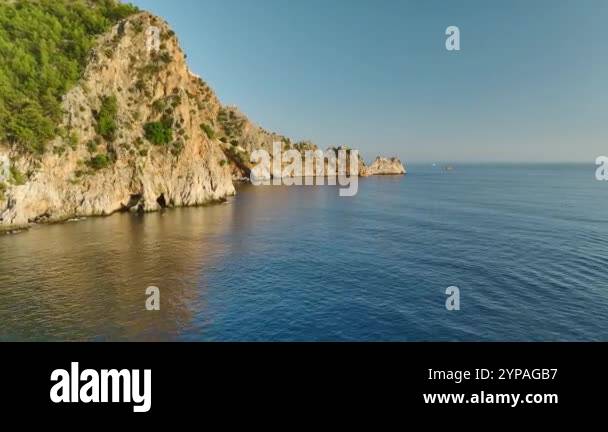 Explore natures wonder as a mountain stands amidst the sea in Alanya ...