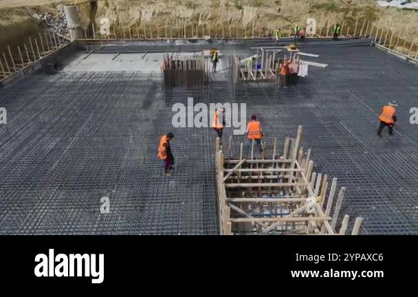 Watch workers prepare the foundation and reinforce the rebar for a ...