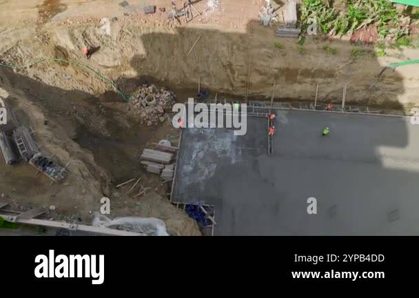Watch concrete being poured into the foundation to support the ...