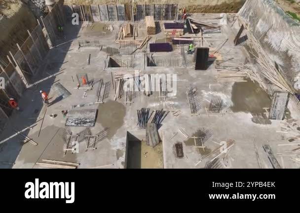 See the preparation and building of load-bearing walls and floors in progress at a busy ...