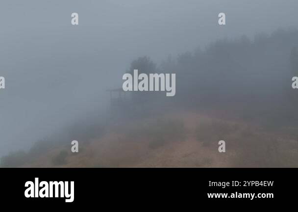 See the majestic mountain peaks covered in clouds, with green forests ...