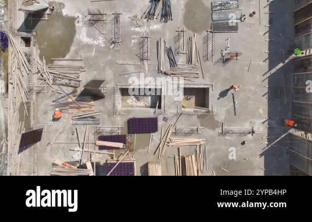 Observe the construction workers building load-bearing walls and ...