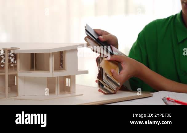Slow motion home designer using architectural equipment draw a ...